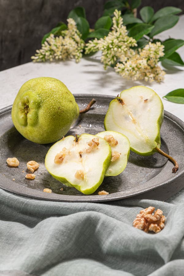 Tasty Pears with Nuts. a Table Decorated with Flowers and a Plate of ...