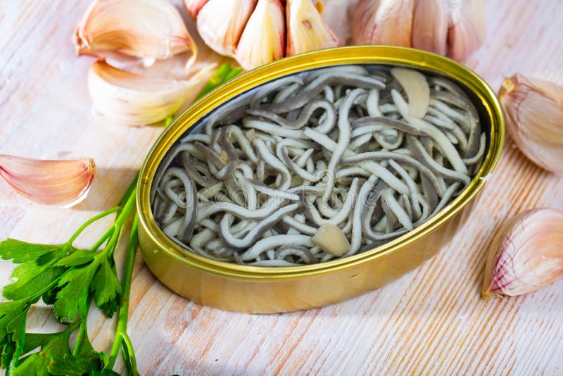 Pickled Eels in Open Tin Can with Garlic at Table Stock Photo - Image ...