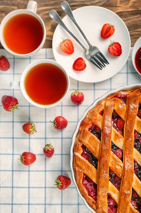 Tasty Pie with Berries and Cups of Aromatic Tea on Table Stock Image ...