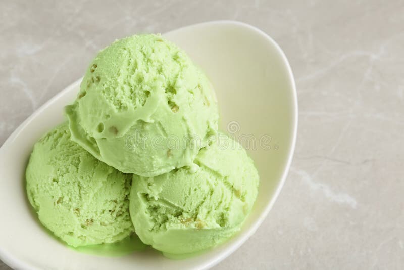Tasty Pistachio Ice Cream on Light Table, Closeup Stock Photo - Image ...