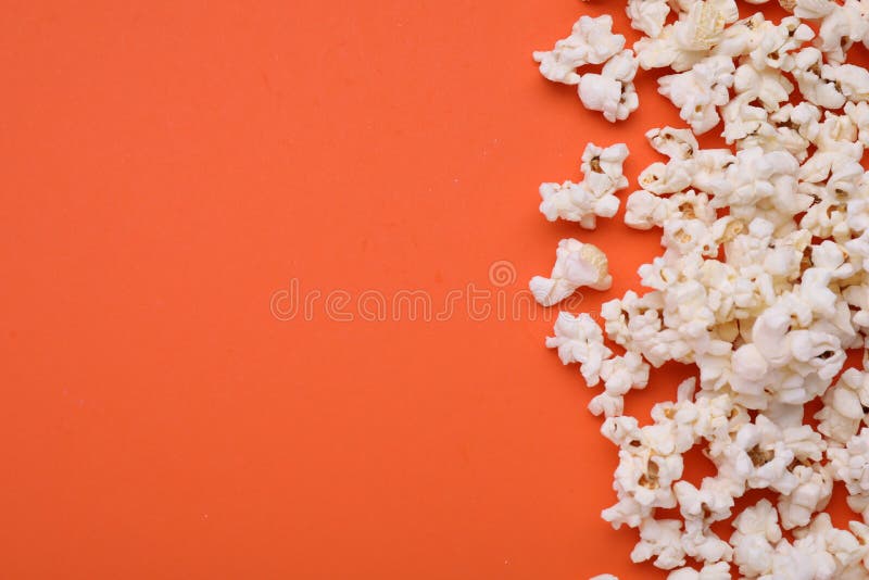 Tasty Popcorn Scattered on Orange Background, Flat Lay. Space for Text ...