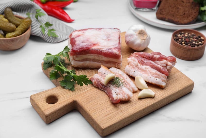 Tasty Pork Fatback with Garlic and Herbs on White Marble Table Stock ...