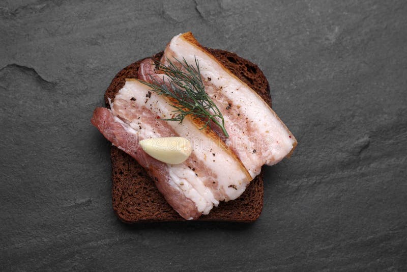 Tasty Pork Fatback with Rye Bread Slice, Garlic and Dill on Black Table ...