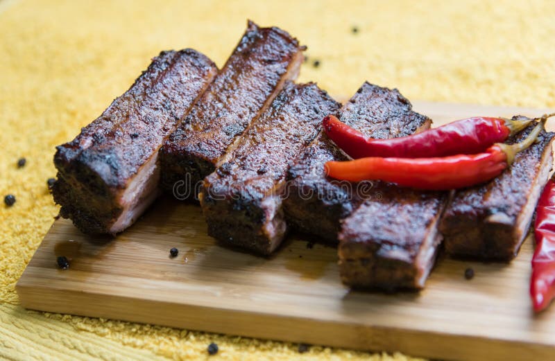 Tasty Pork Ribs with Red Pepper on the Board Stock Image - Image of ...