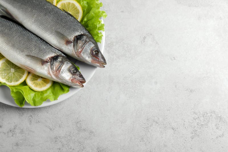 Tasty Sea Bass Fish on Grey Textured Table, Top View. Space for Text ...