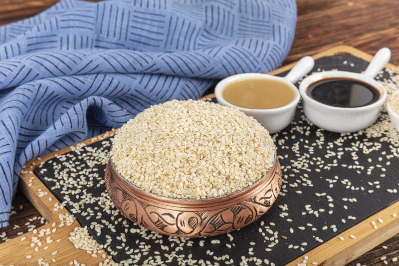 Tasty Sesame Paste and Seeds. Closeup of Lots of White Sesame Seeds ...