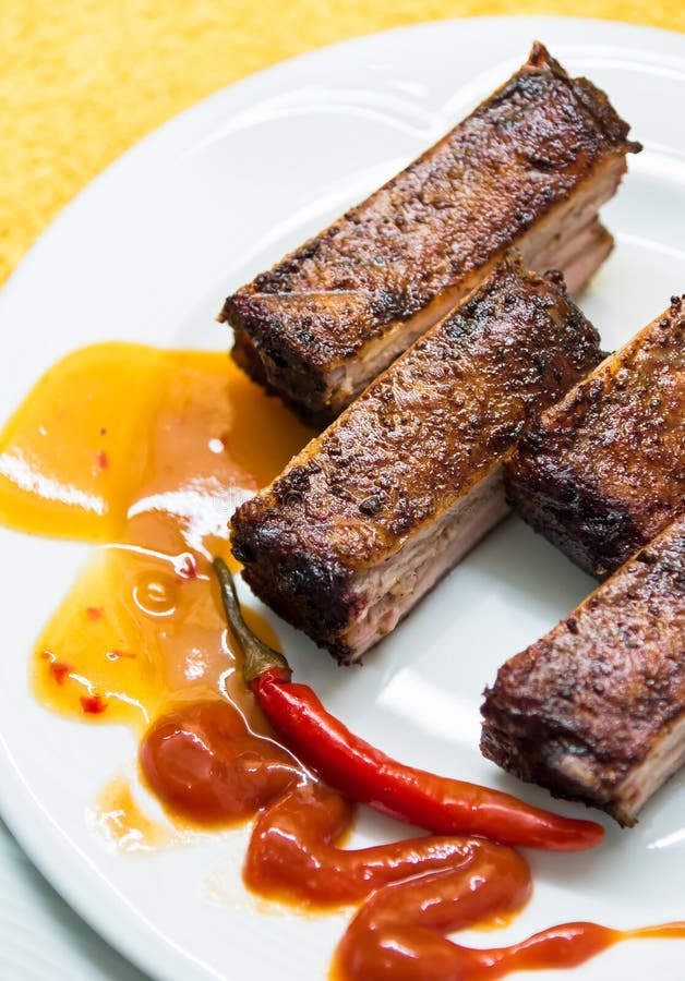 Tasty Smoked Pork Ribs with Red Pepper on the Plate Stock Photo - Image ...