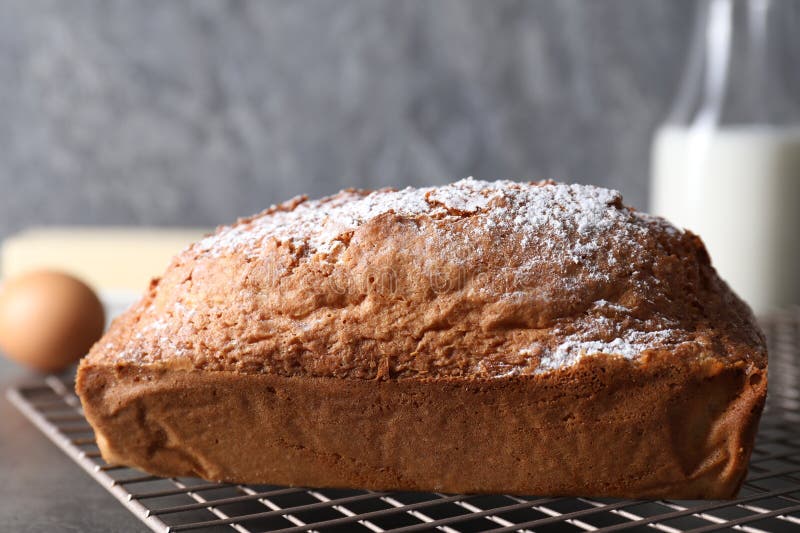 Tasty Sponge Cake with Powdered Sugar on Grey Table, Closeup Stock ...
