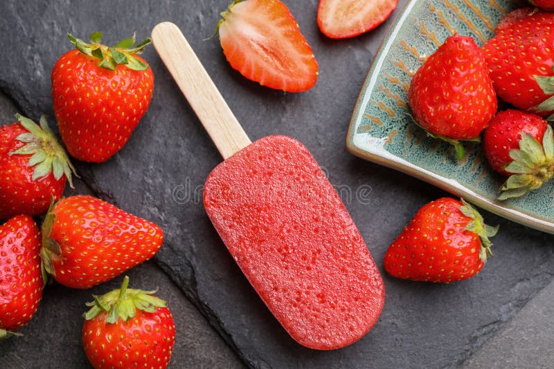Tasty Strawberry Ice Pop on Dark Table, Flat Lay. Fruit Popsicle Stock ...