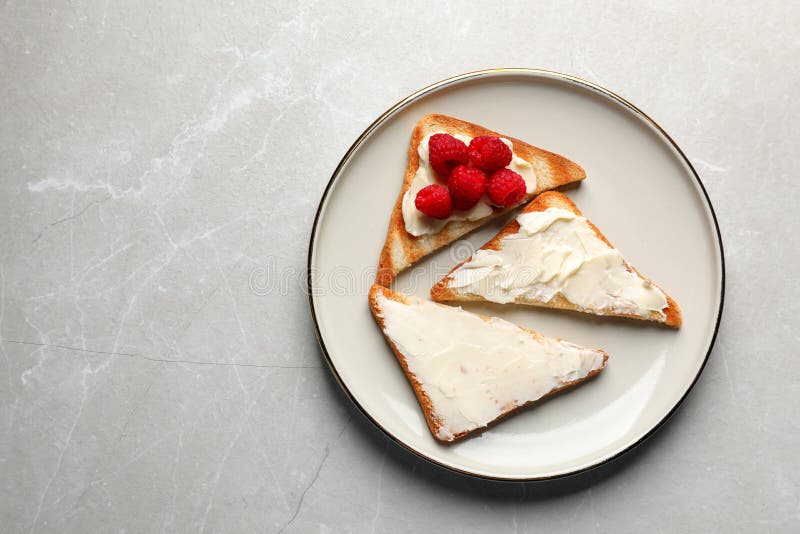 Tasty Toasts with Butter and Raspberries on Light Grey Marble Table ...