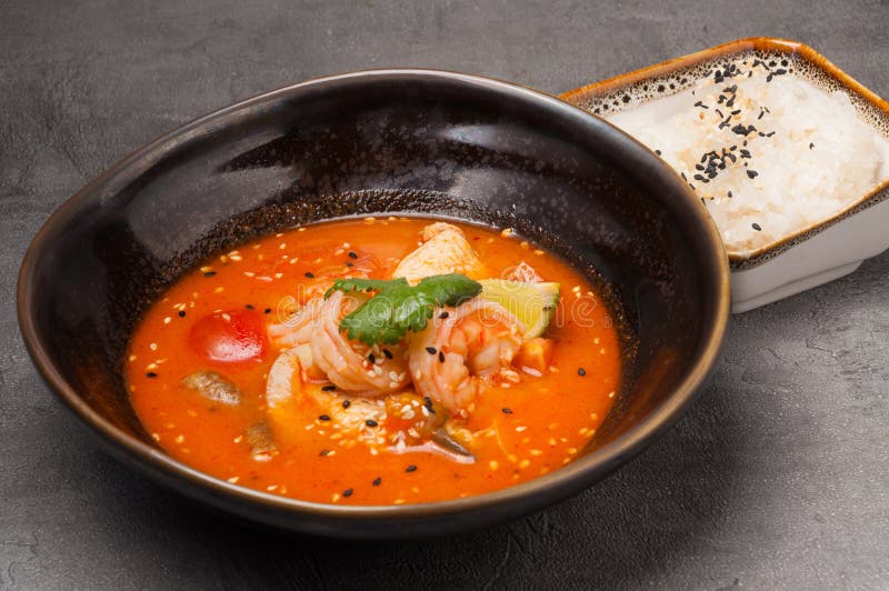 Tom Yam with Seafood in a Dark Dish and Rice Stock Image - Image of ...