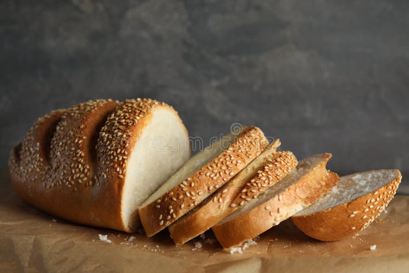 Tasty Wheat Bread on Parchment Paper Against Grey Stock Photo - Image ...