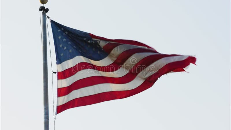 Tattered and Frayed American Flag on Flagpole Flaps in Wind Stock ...