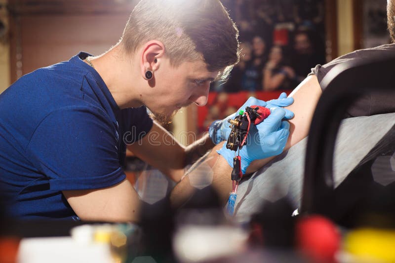 Tattoo Artist Creating a Tattoo on a Man& X27;s Arm Stock Image - Image ...