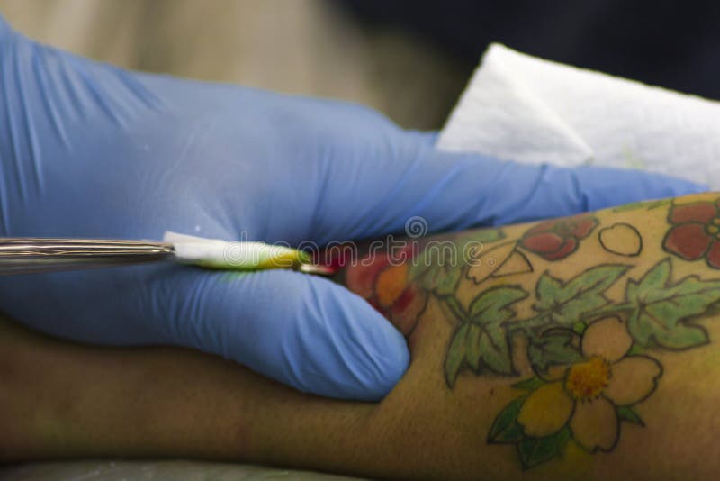 Tattoo Artist Realizes a Tattoo on His Arm Hands Stock Image - Image of ...