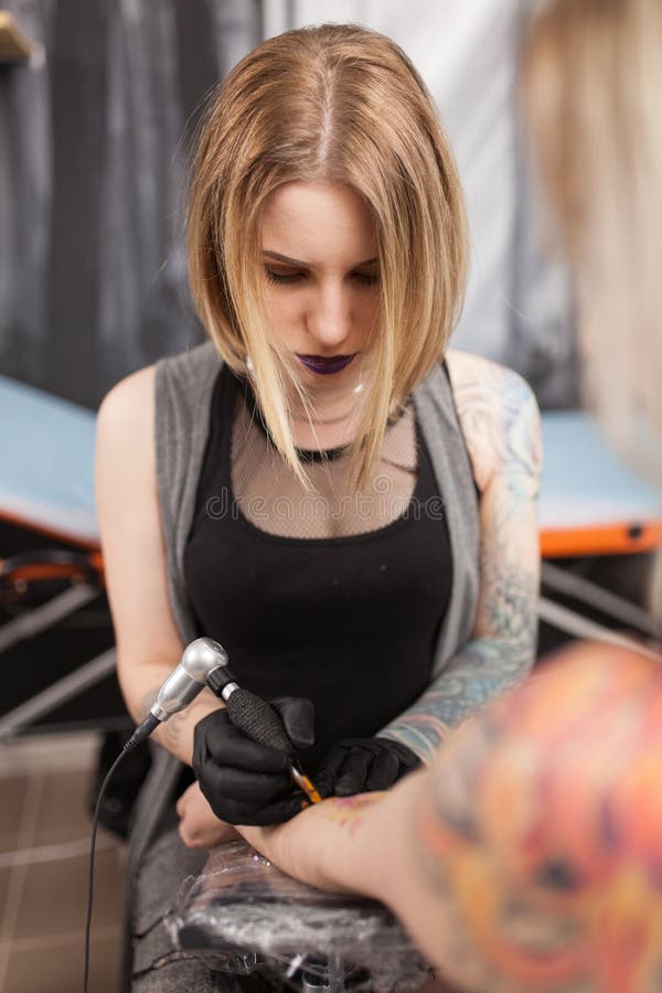 Tattoo artist in a studio stock image. Image of master - 95579459