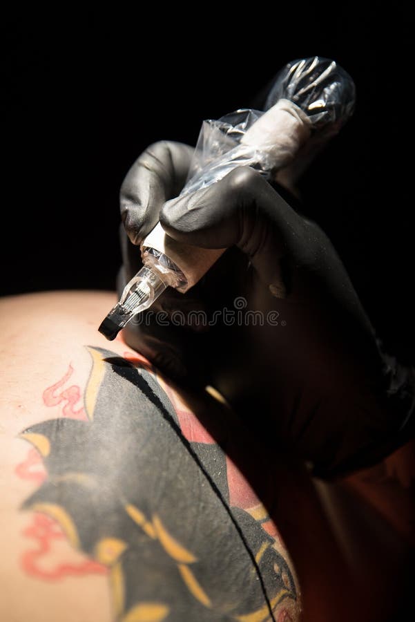 Tattoo artist at work stock image. Image of tool, concentration - 92171961