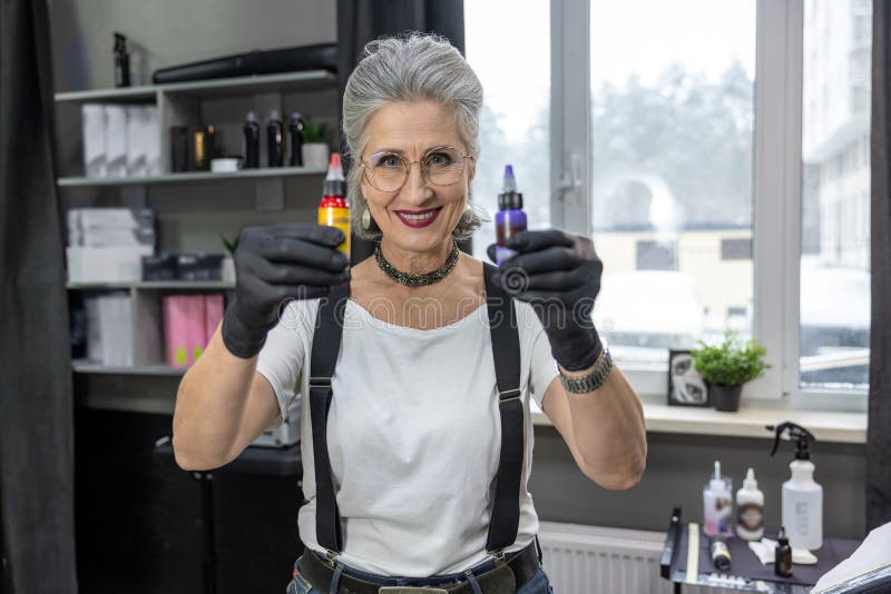 Female Tattoo Master Holding Bottles with Tattoo Ink Stock Photo ...