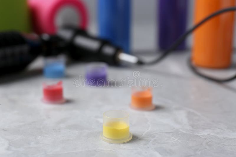 Tattoo Inks and Professional Tools on Light Grey Table, Closeup Stock ...