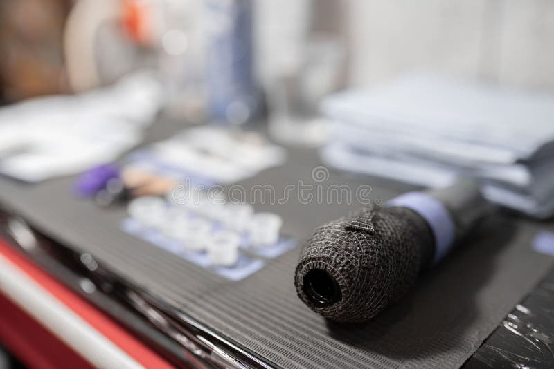A Tattoo Machine is Resting on the Work Table Next To the Other Tools ...