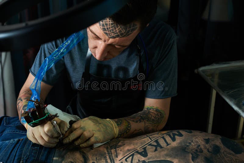Tattoo Master Ends a Tattoo on the Back Stock Image - Image of needle ...