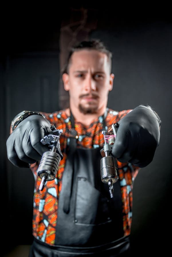 Master of the Art of Tattooing Poses in a Tattoo Studio Stock Photo ... Master of the Art of Tattooing Poses in a Tattoo Studio Stock Photo ...