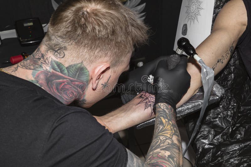 Tattoo Master in the Process of Creating a Tattoo Stock Photo - Image ...