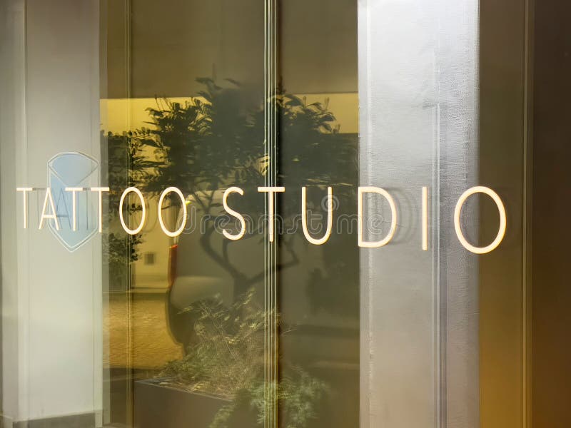 Tattoo Studio Sign on Glass Door with Interior Reflection Editorial ...