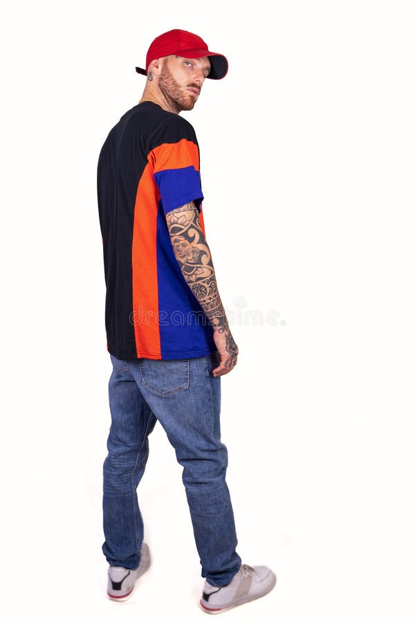 Tattooed Rap Singer Posing in Studio Wearing Red Cap Stock Photo ...