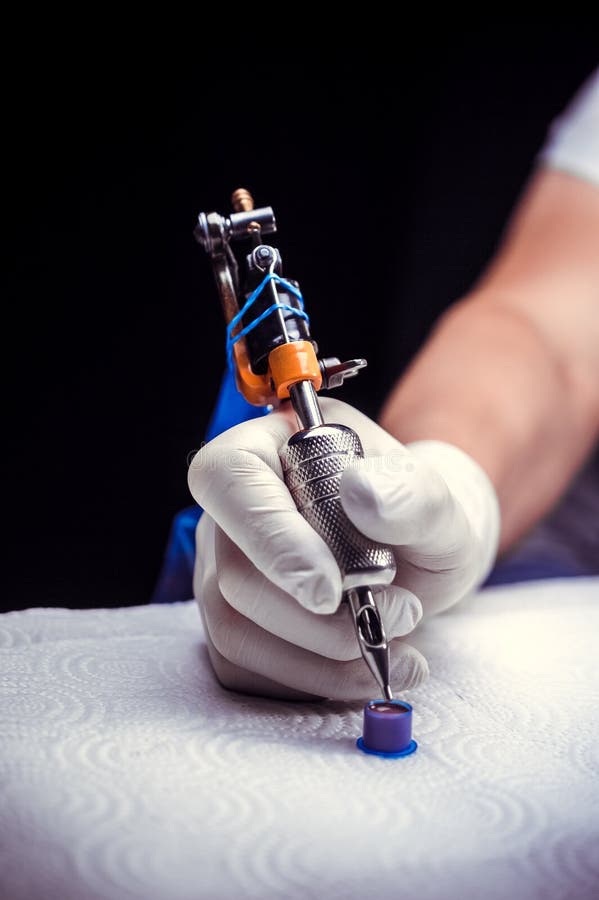 Tattooer`s Hand and a Tattoo Machine. Stock Image - Image of create ...