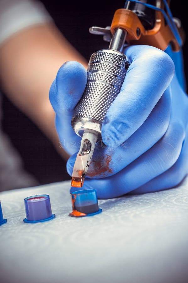 Tattooer& X27;s Hand and a Tattoo Machine. Stock Image - Image of ...