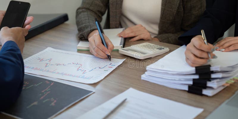 Tax Analysis Teamwork. Professionals Working on Financial Documentation and Calculations during ...