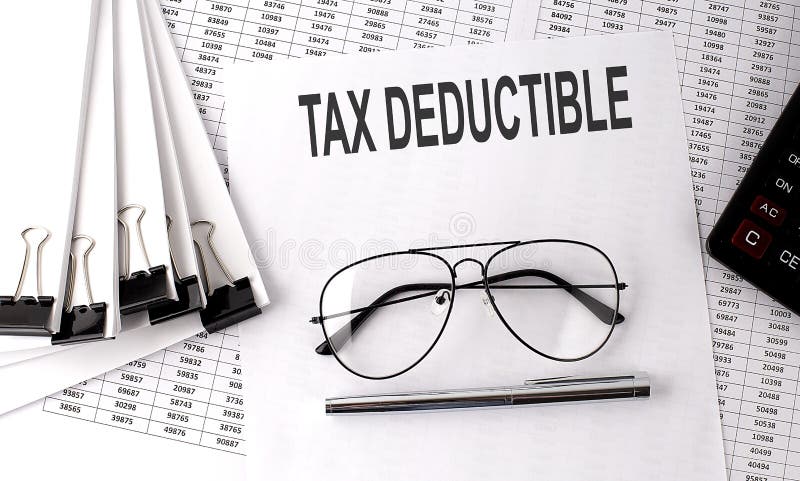 TAX DEDUCTIBLE Text on Paper with Chart and Office Tools , Business ...
