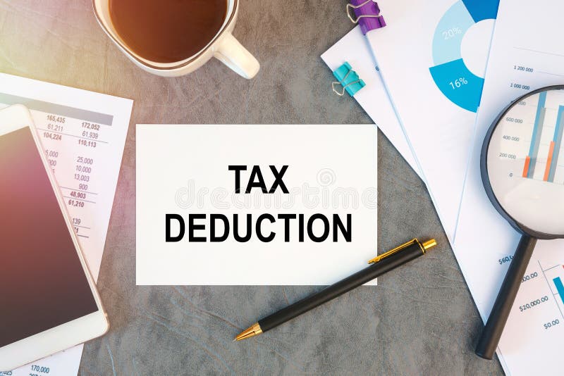 TAX DEDUCTION is Written in a Document on the Office Desk, Keyboard and ...