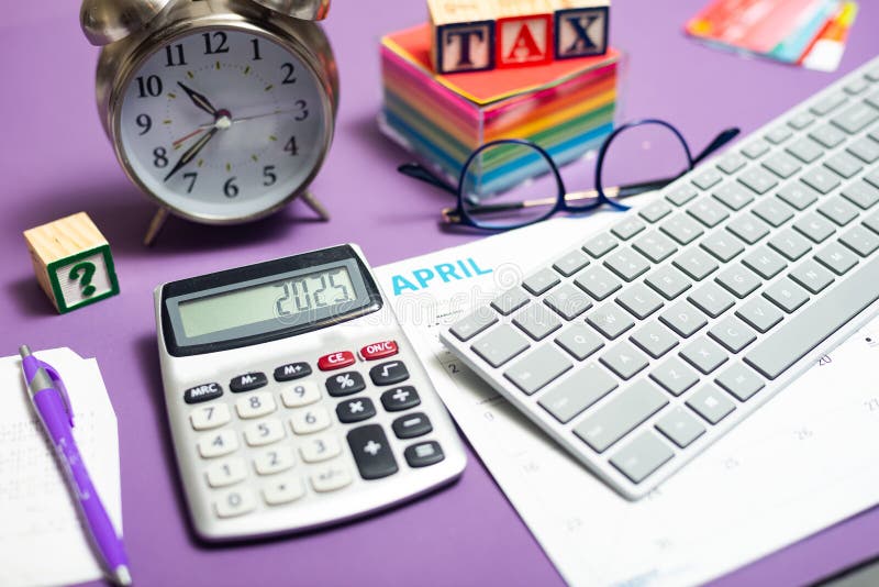 Tax Filing Deadline. a Computer and Calculator on a Desk, a TAX Sign ...