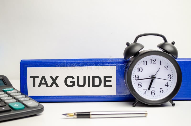 TAX GUIDE Word on Paper Folder with Clock and Calculator Stock Photo ...
