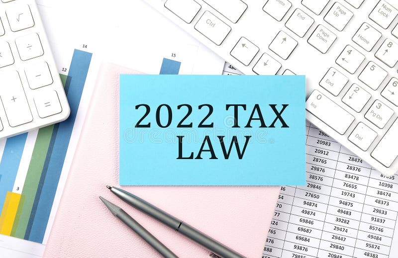 2022 TAX LAW Text on Blue Sticker on Chart with Calculator and Keyboard ...