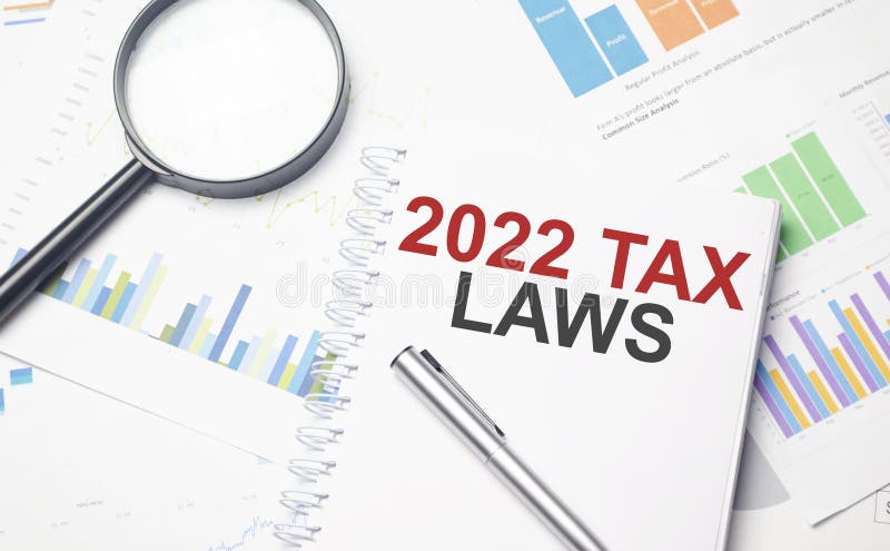 2022 Tax Laws Text on a Blue Sticker on the Background of a Sheet with ...