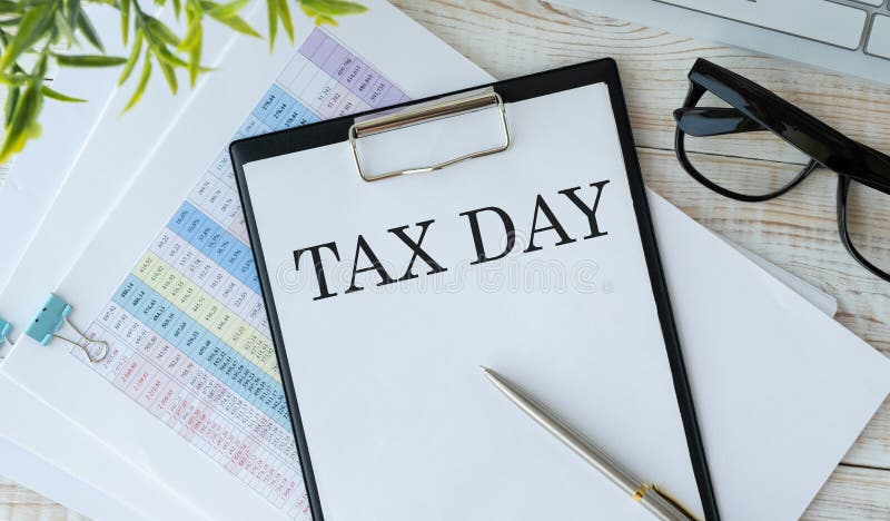 Tax Return Form and Hand Written Tax Day Text on a Calendar on Table ...