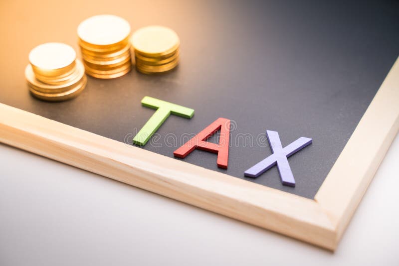 Tax Text on Blackboard with Coin Under Light Stock Photo - Image of ...