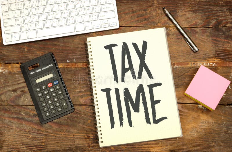 Tax Time on Notebook, Documents, Computer Keyboard, Calculator on Wood ...
