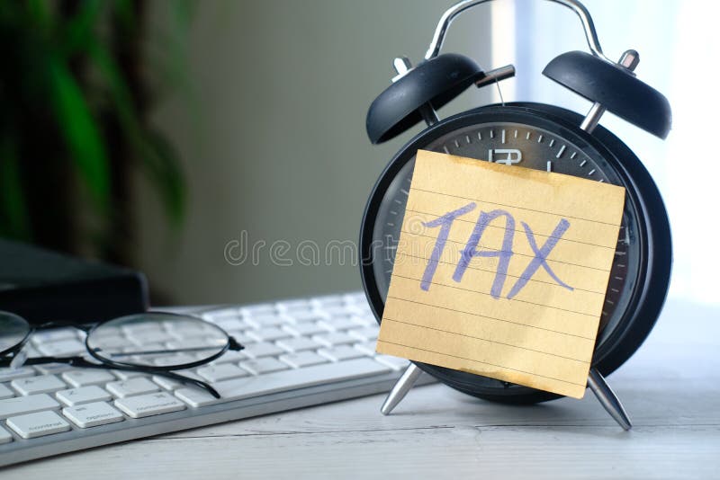 Tax Word on Alarm Clock with Stationary on Table. Stock Photo - Image ...