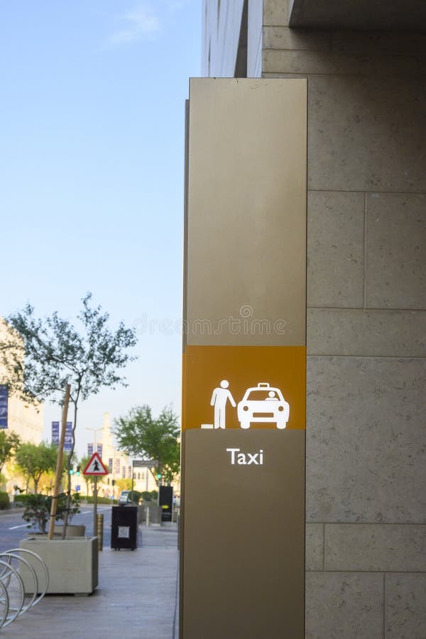Taxi Sign Hung on the Building Wall Stock Photo - Image of urban, blue ...