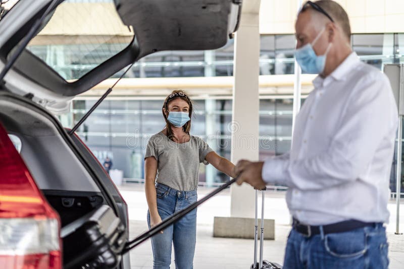 A Taxiuber Driver Helping A Passenger With Her Luggage At The Airport Stock Image Image Of