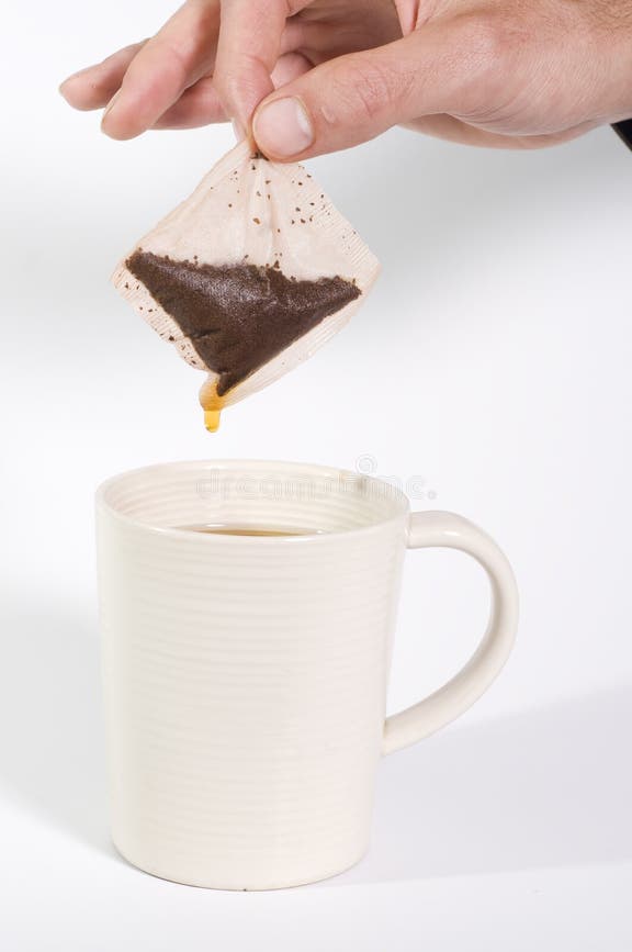 Tea bag and cup stock image. Image of hand, white, holding - 10552957