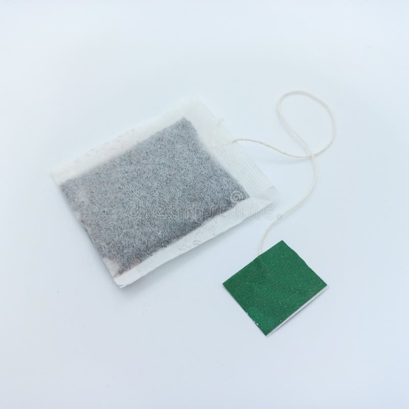 Tea Bag with Green Tag Isolated on White Background. Tilted Position on ...