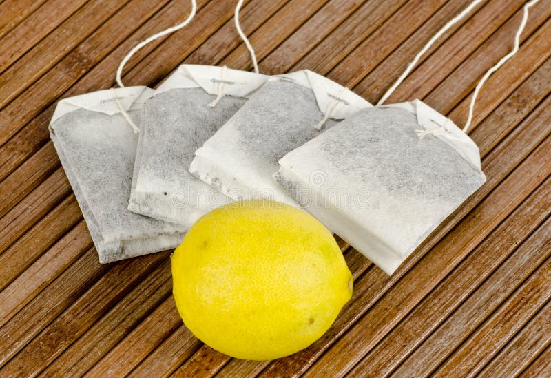 Tea bags and lemon stock photo. Image of lemon, bags - 128124082