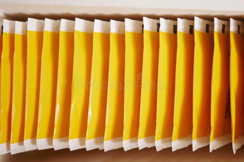 Tea Bags in Yellow Packet on Table Stock Photo - Image of porcelain ...