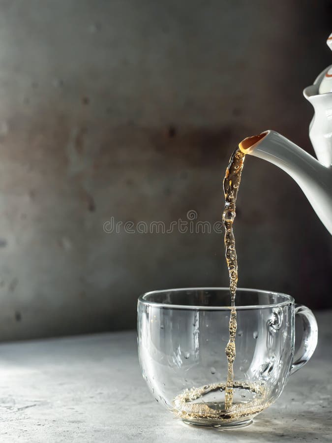 Tea Being Poured into Glass Tea Cup with Steam Stock Photo - Image of ...