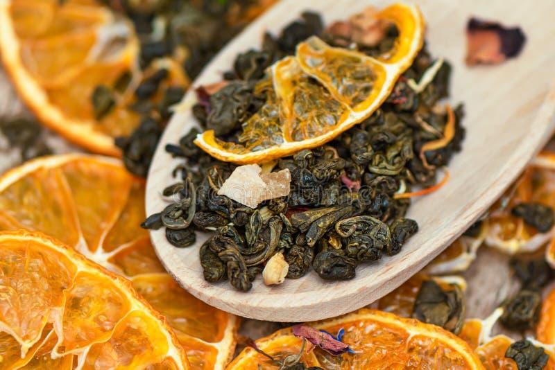 Tea Buds with Dried Oranges. Green Tea with Dried Citruses in a Wooden ...